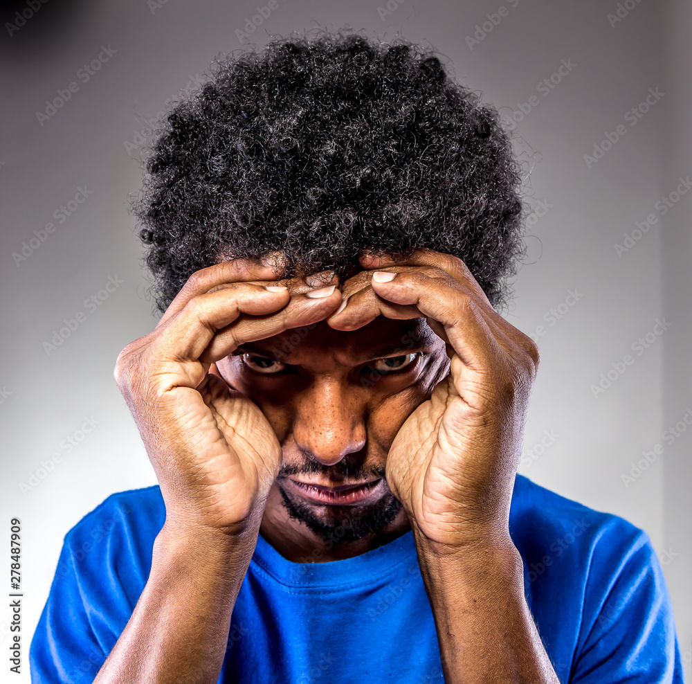 A close up view on the face of a fed-up and disappointed African man in ...
