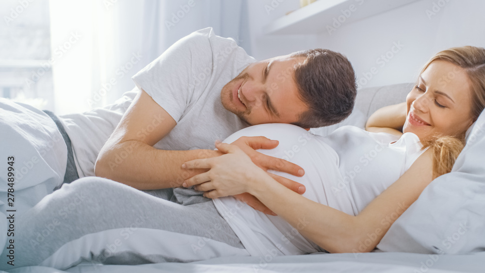Happy Young Couple Cuddling Together in the Bed, Young Woman is ...