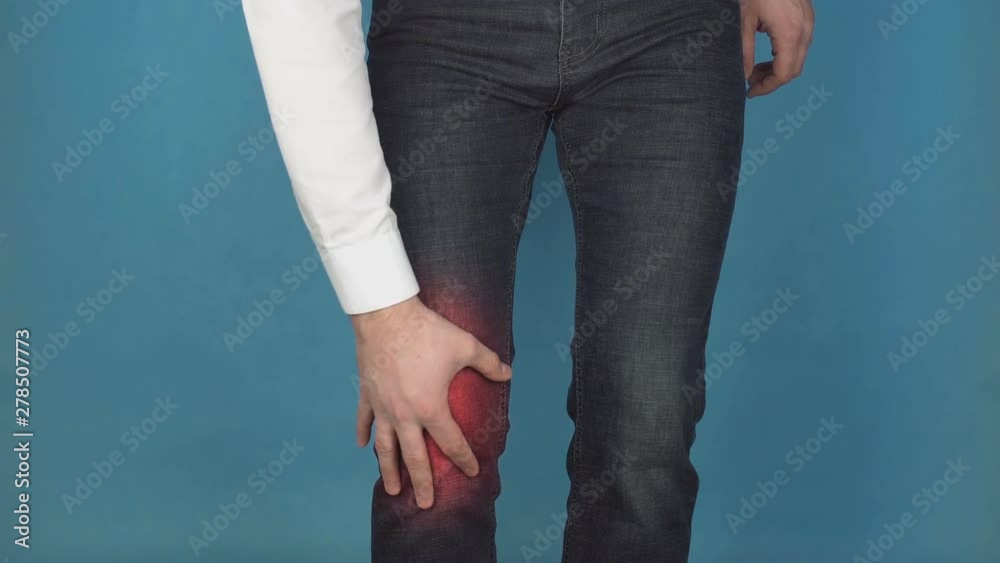 A man clings to a sore knee, pain and inflammation in the knees, the ...