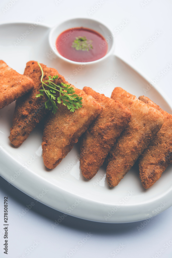 crispy Potato triangles or batata vada covered with bread crumbs and ...