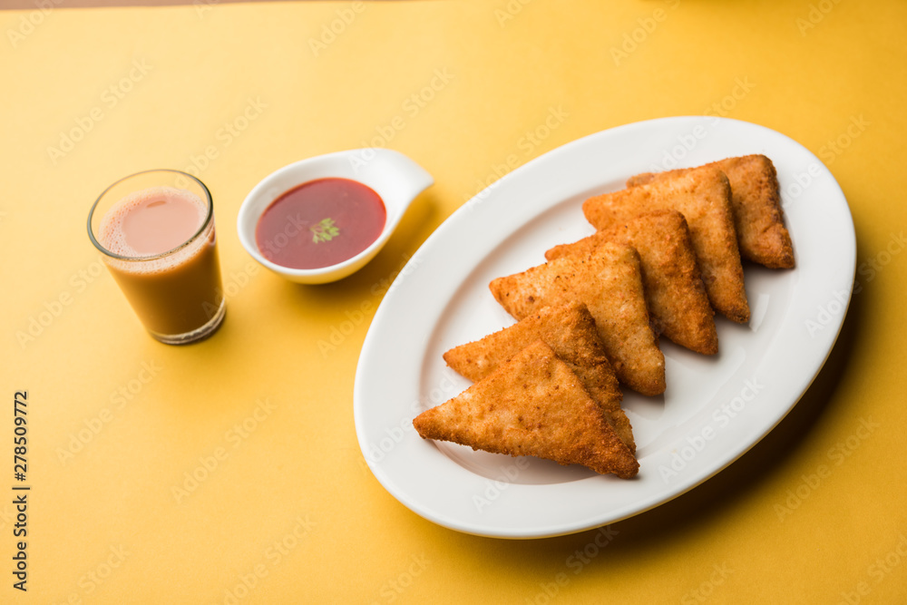 crispy Potato triangles or batata vada covered with bread crumbs and ...
