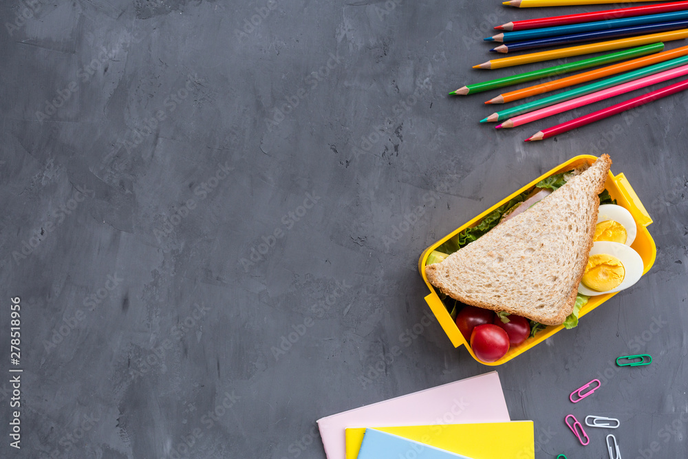 School supplies and lunch box with sandwich and vegetables. Back to ...