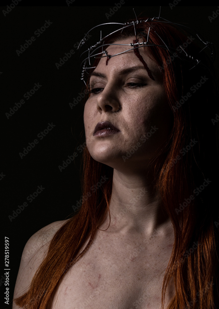 tormented beautiful woman with a wreath of barbed wire on the head on a ...