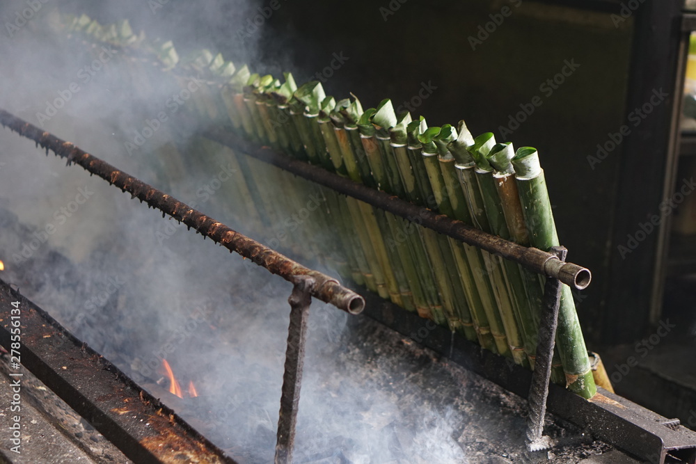 Making (Lemang) glutinous rice in bamboo cooked using firewood is a ...