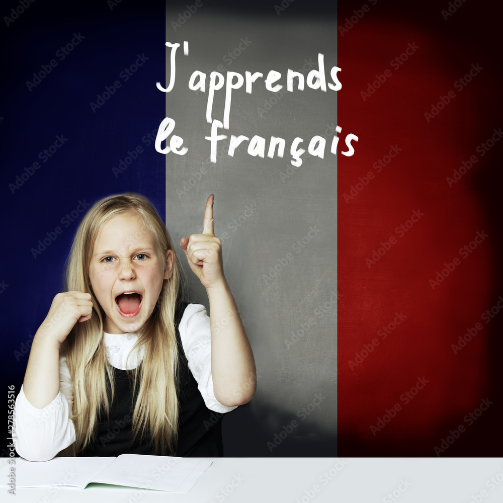 Learn french language concept. Happy child girl student pointing up on ...