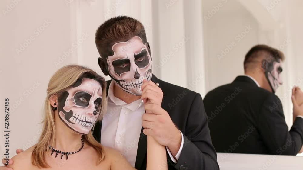 Creepy couple of actors with scary Halloween makeup in vintage costumes ...
