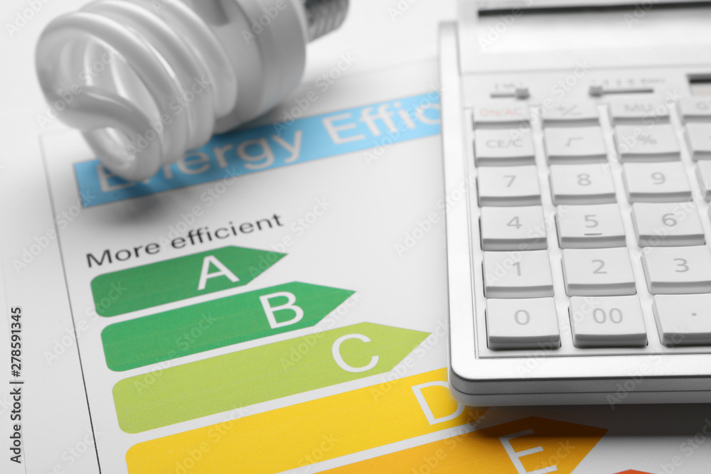 Energy efficiency rating chart, fluorescent light bulb and calculator ...