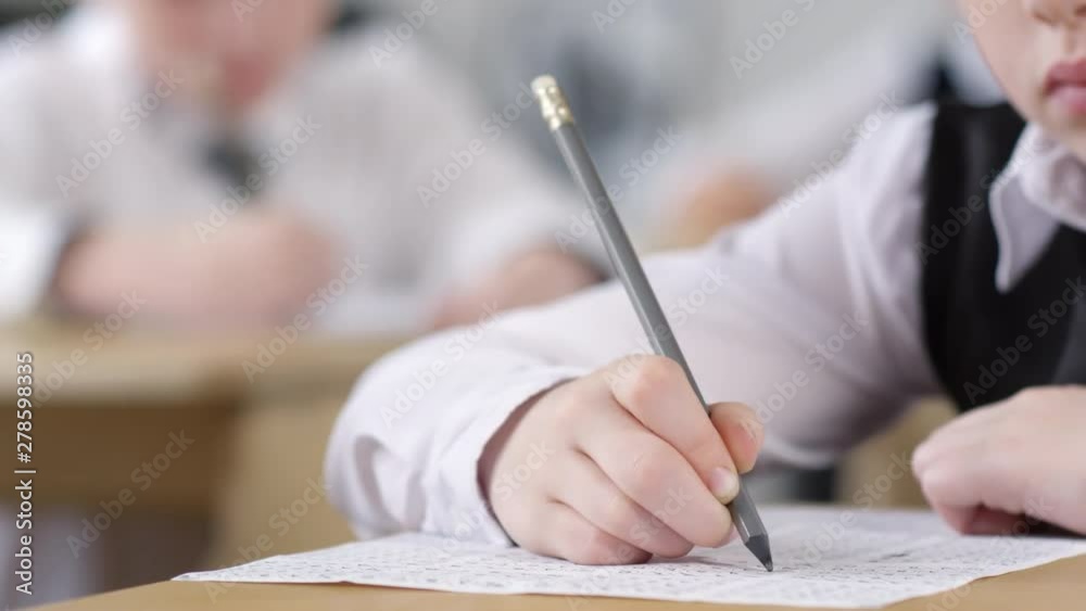 Tracking close-up hands shot of unrecognizable schoolgirl, wearing ...