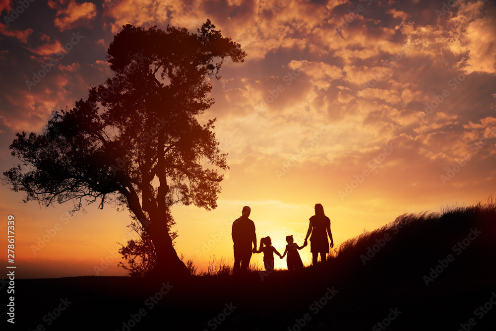 Happy family silhouette standing on against sunset time Stock Photo ...