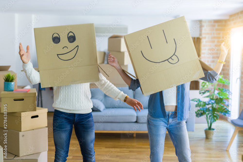 Funny couple wearing cardboard boxes with fun crazy emoji faces over ...