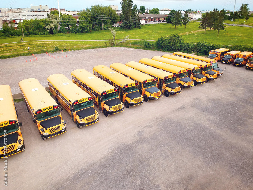 School bus vehicles ready for school educational season. Drone aerial ...