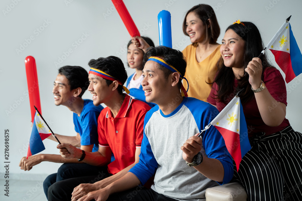 filipino group of people holding philippines flag celebrating ...