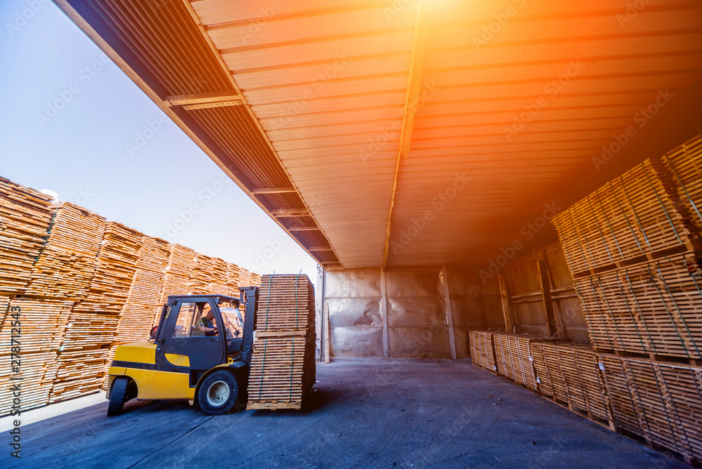 Forklift loader load lumber into a dry kiln. Wood drying in containers ...