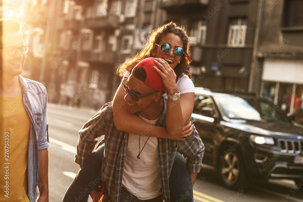 Group of friends hangout at the city street.They embrace each other and ...