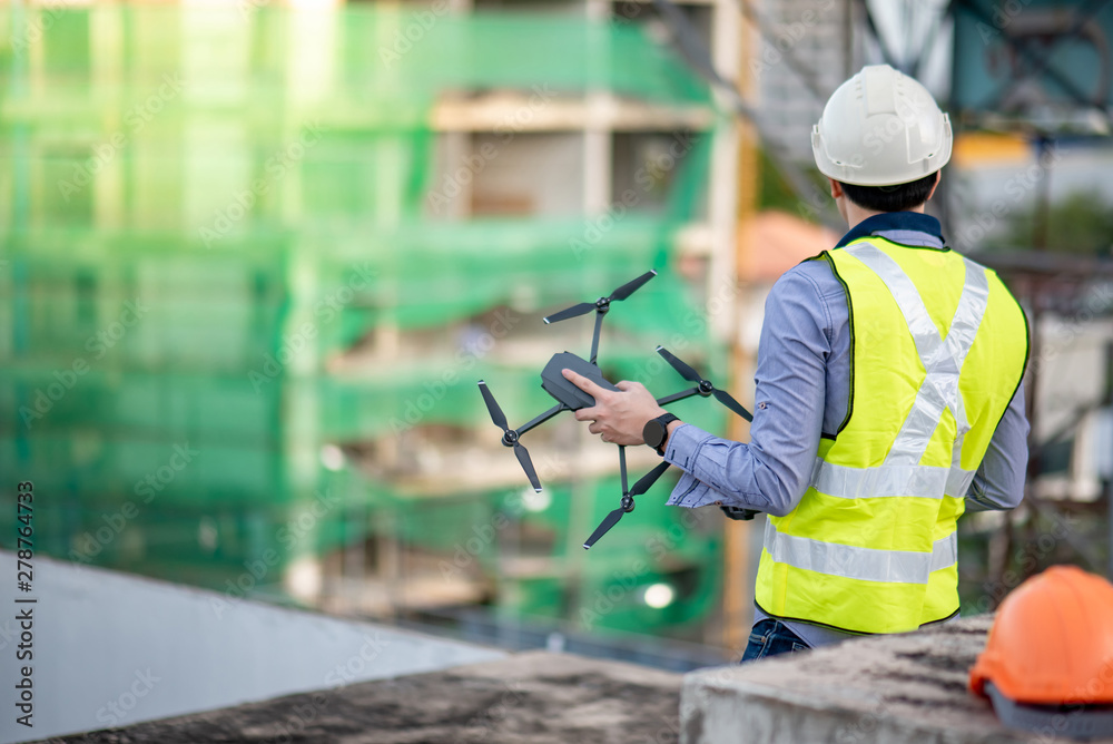 Asian engineer man holding drone at construction site. Male worker ...