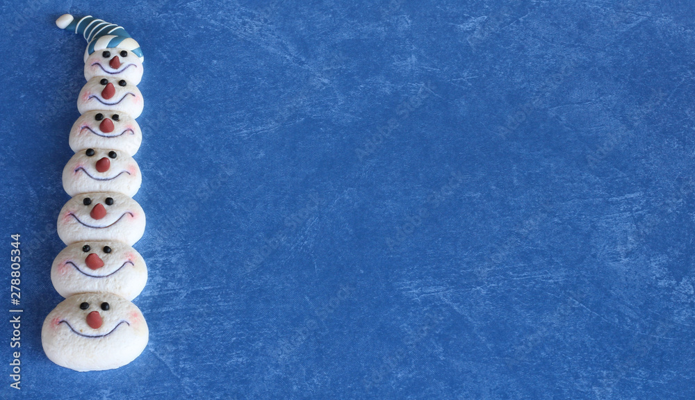 stacked snowman faces with carrot noses the top one wearing a striped ...