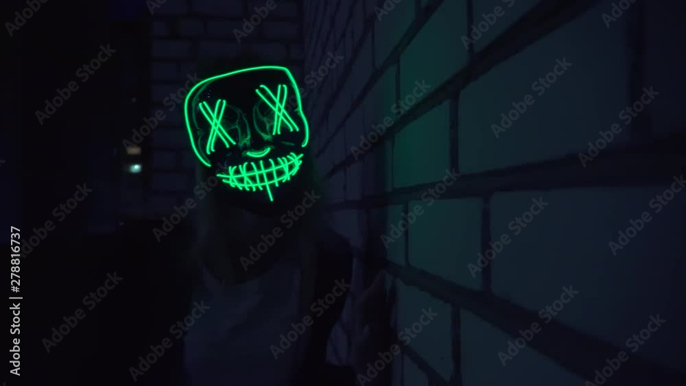 I pop up when the rave starts. Brick wall. A man wears an exotic LED ...