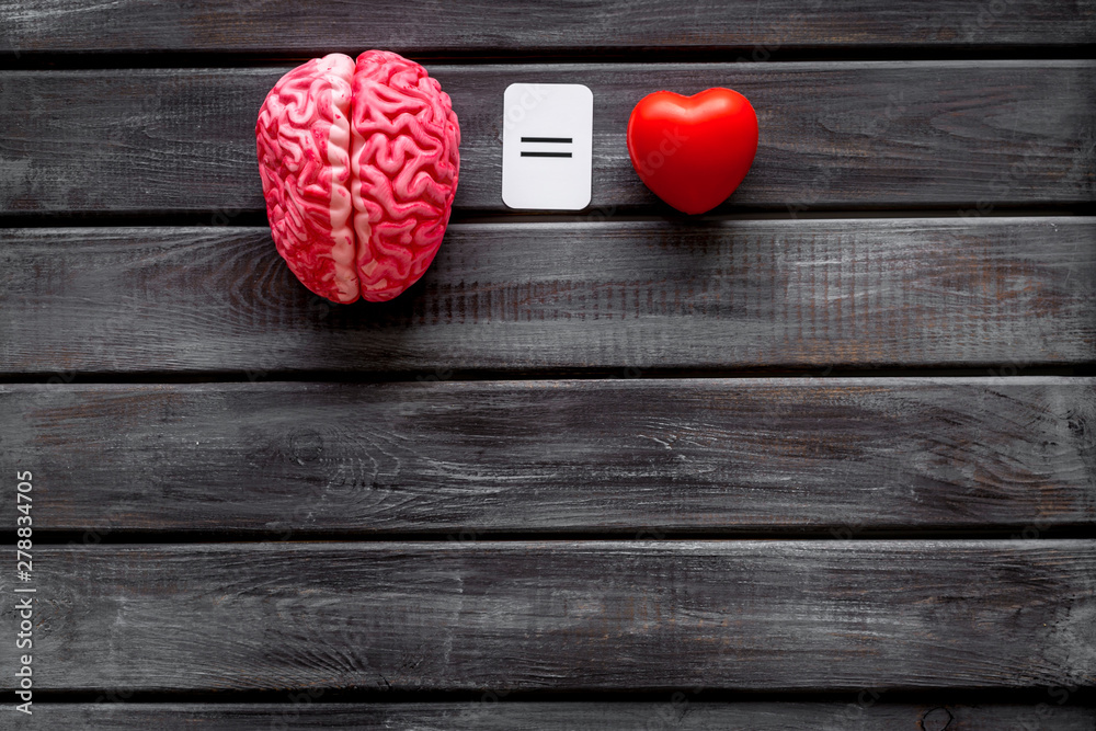 feelings and mind concept with brain equals to heart on wooden ...