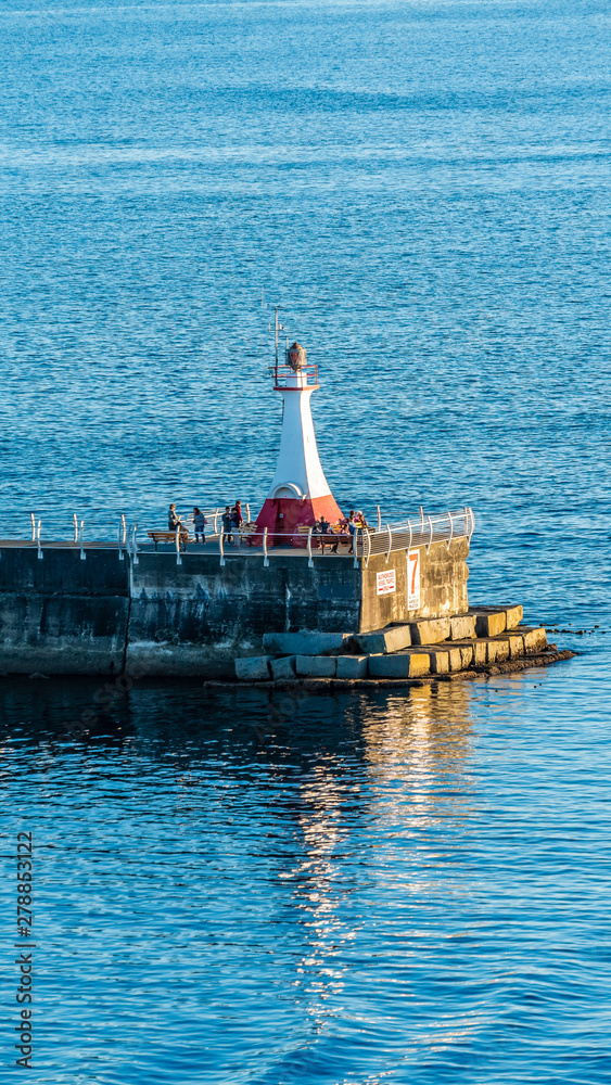 People on the marine corridor of Ogden Point Breakwater Lighthouse on ...