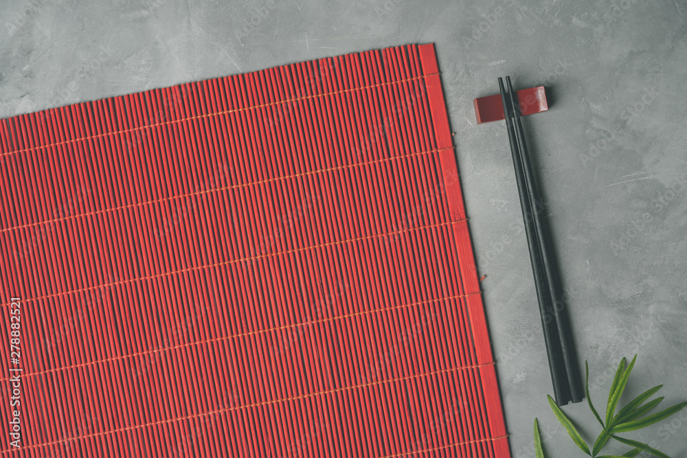 Bamboo mat and chopsticks on gray stone background for your own design ...