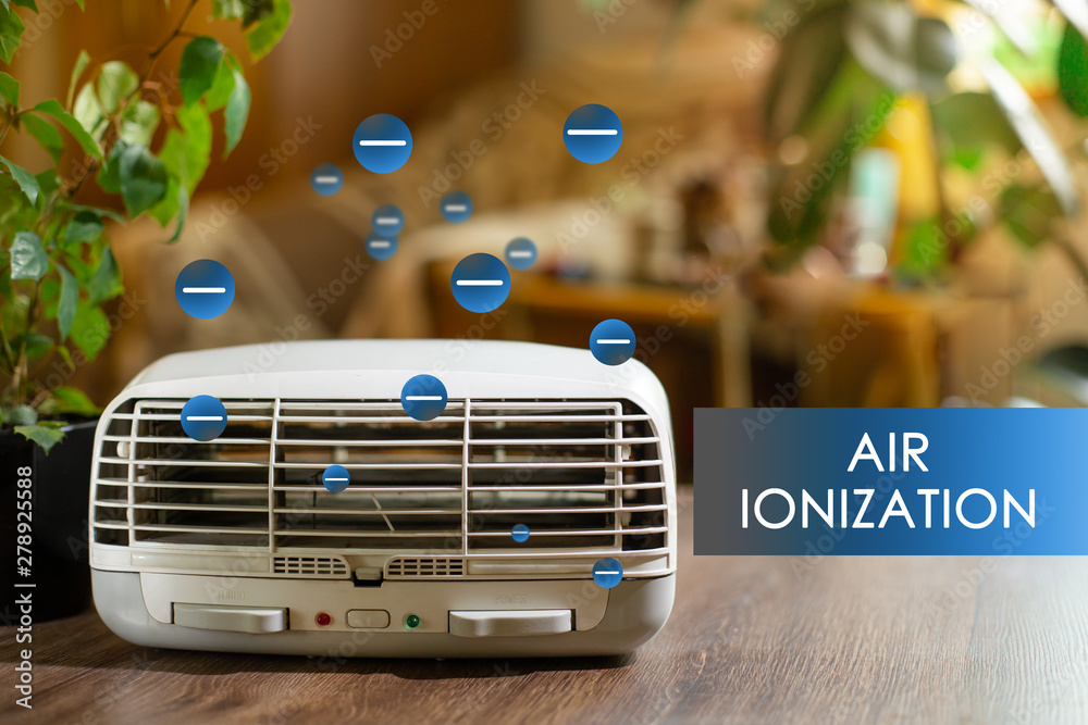Air ionizator doing air ionization in a living room on a wood table ...