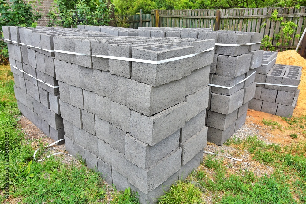 Stack of gray textured cinder blocks for house or fence building ...