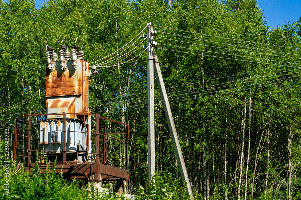 Transformer substation is installed on concrete supports in forest ...
