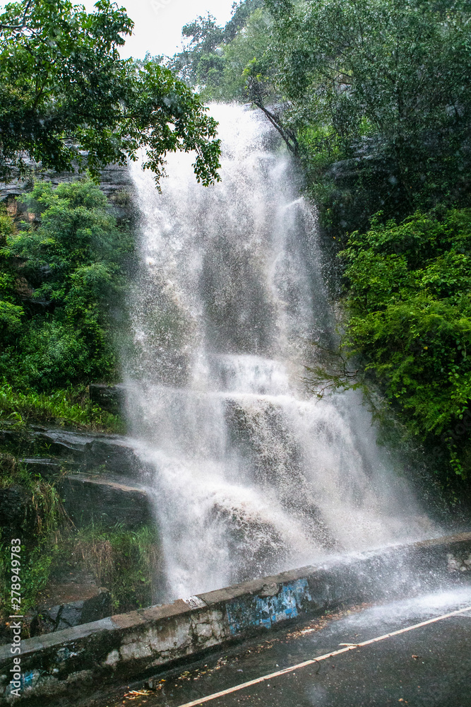 disaster. waterfall after rain pours water onto mountain road. Flooding ...