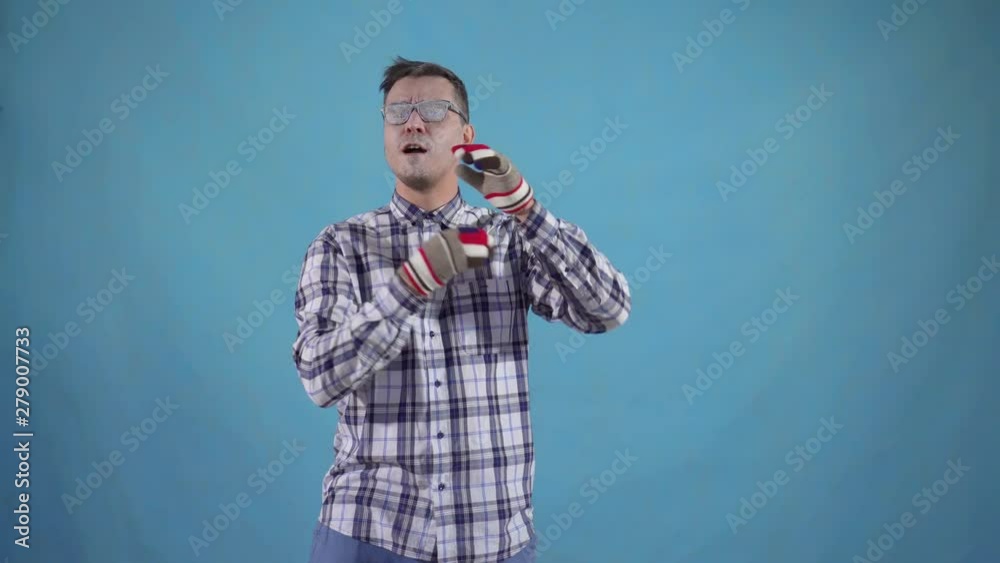 Frozen man covered with frost takes off his scarf and gloves from the ...