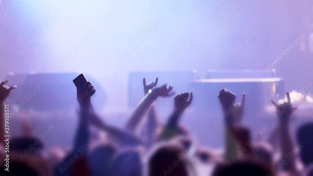 Crowd of people jumping on a rock concert with their hands showing the ...