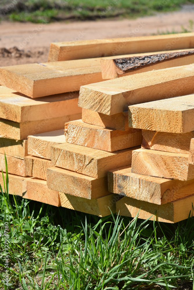 Stacked lumber. Folded wood.Closeup wooden boards.The surface of the ...