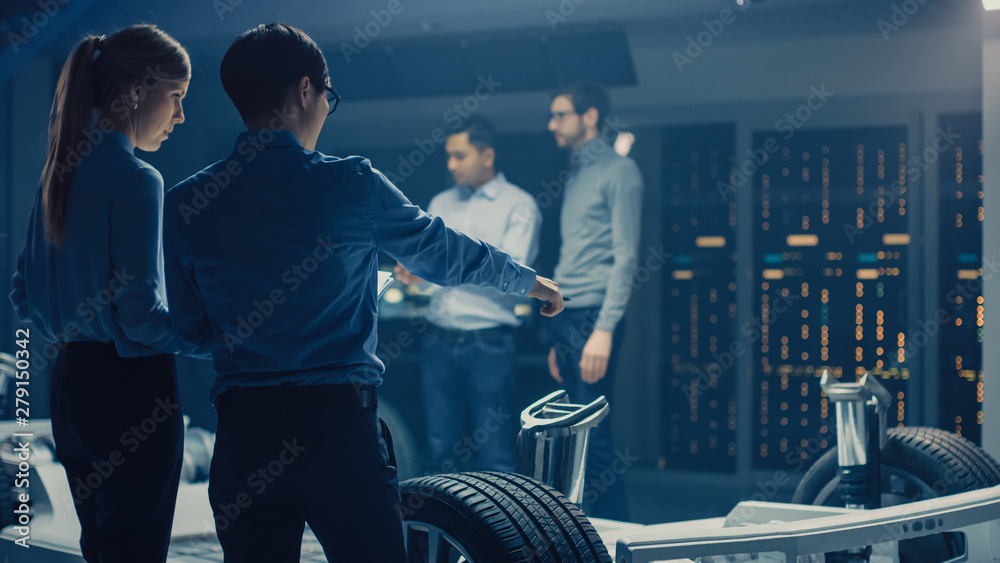 Automobile Engineers Discussing and Designing Electric Car Chassis ...