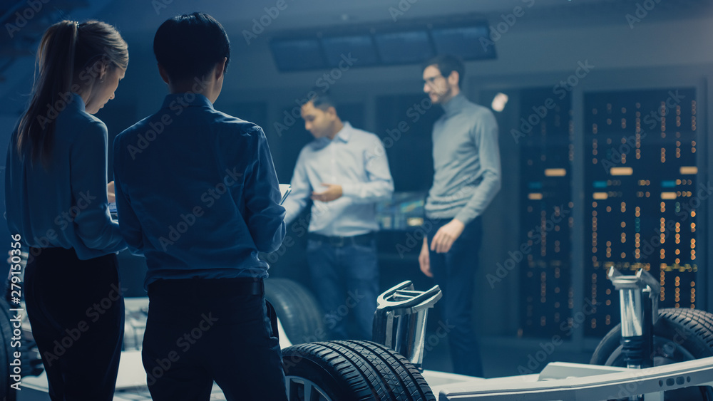 Automobile Engineers Discussing and Designing Electric Car Chassis ...