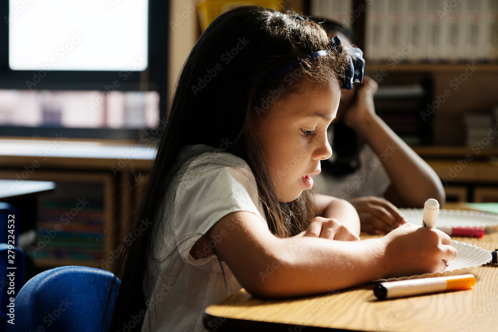 Foto de Side view of student drawing during art class in school do ...