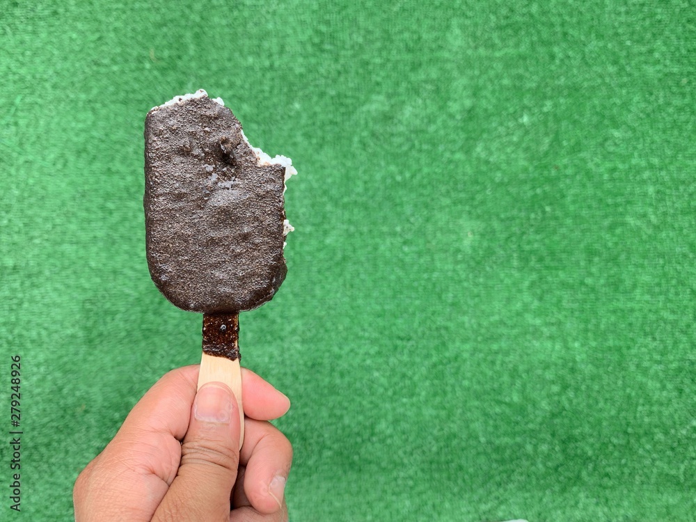 Cookies and cream flavored ice cream sticks with bite marks on the ...