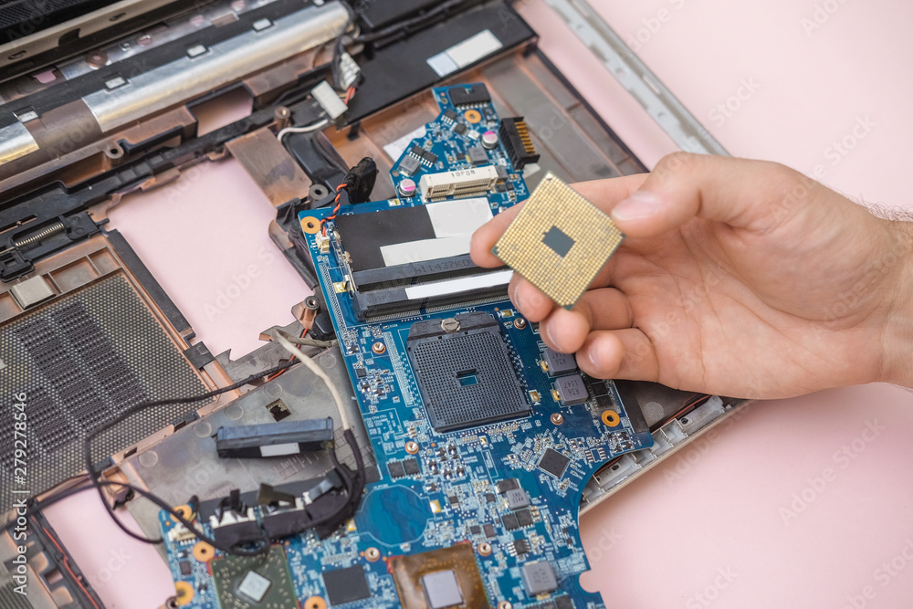 The hands of man repairing the computer. Replacing the motherboard on ...