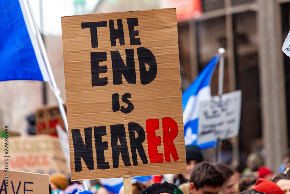 Homemade placard at ecological protest. An ecological campaigner is ...