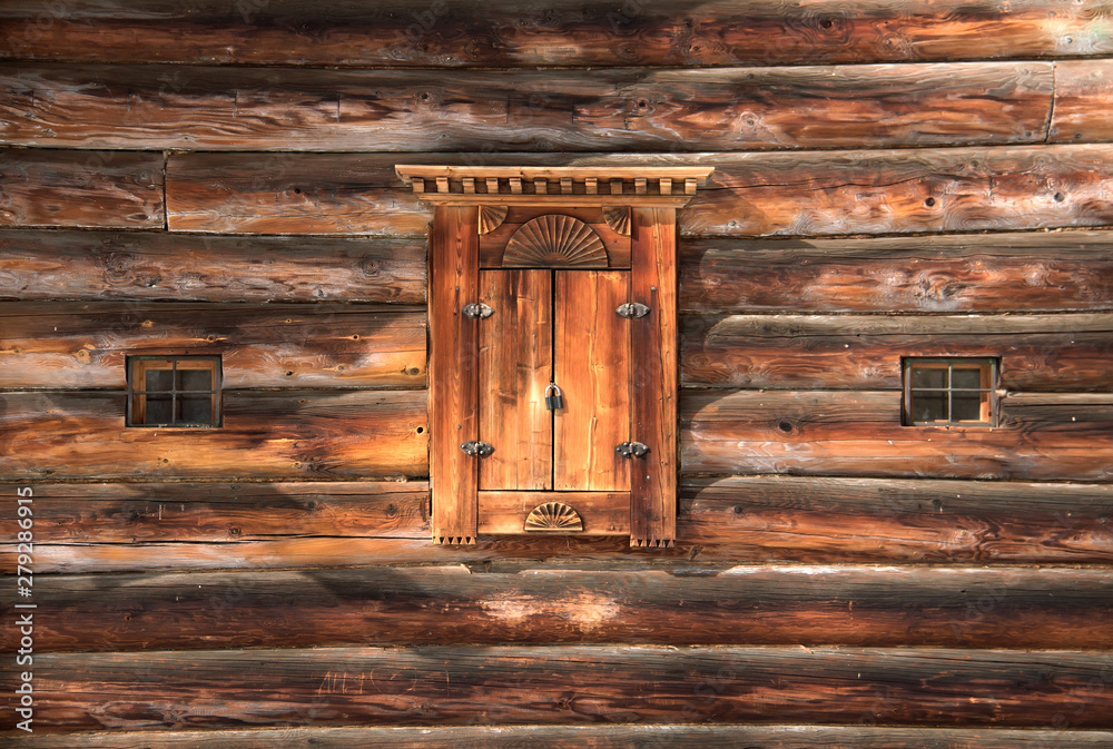 Old wooden window shutters on a log wall. Carved wooden window ...