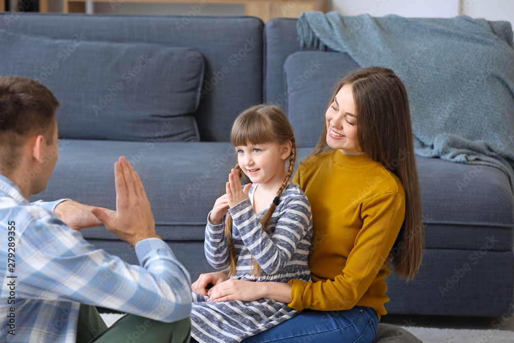 Deaf mute family using sign language at home Stock Photo | Adobe Stock