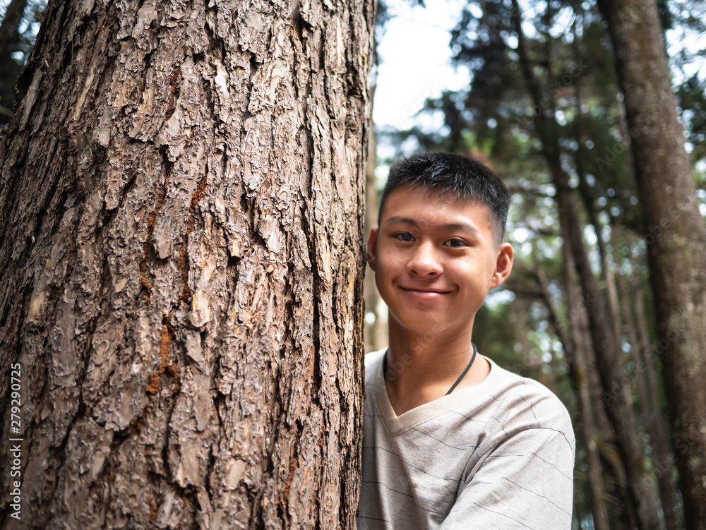 Young Boy Hugging A Tree