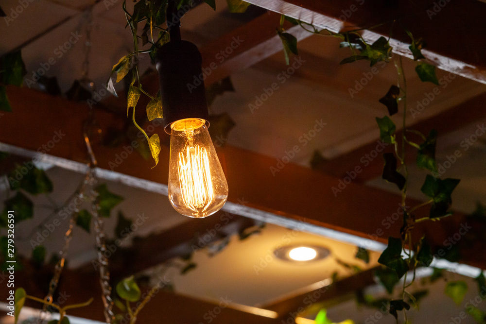 Modern light bulb in eco-friendly bistro A low angled close up view of ...