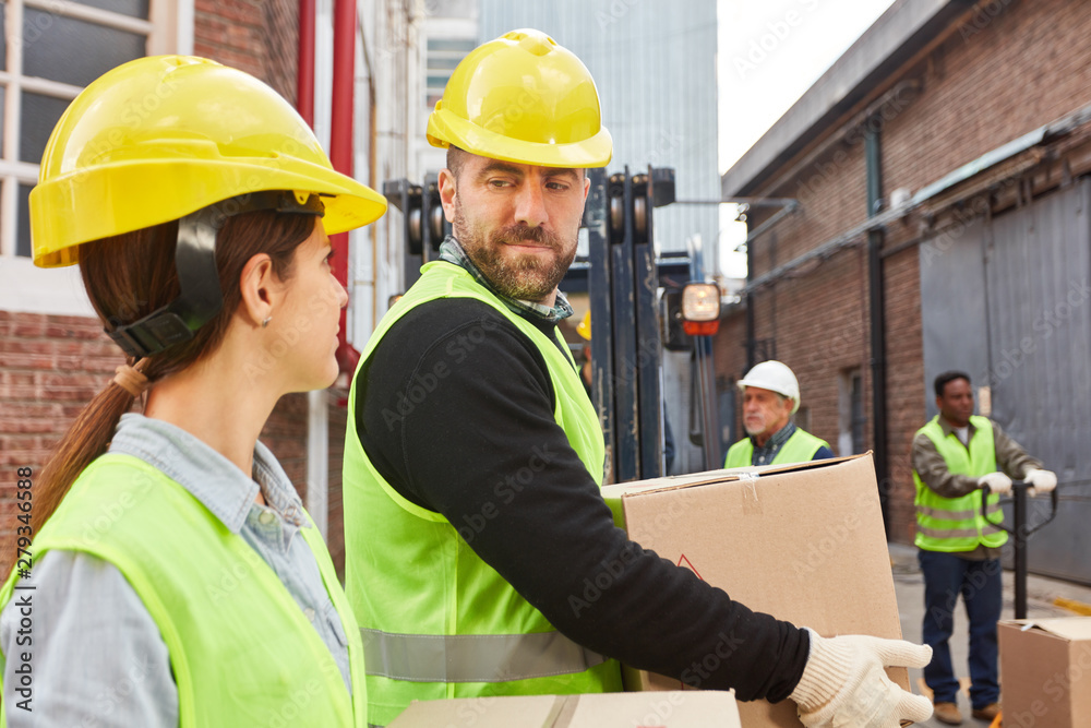 Logistics workers of a freight carrier carry packages Stock Photo ...