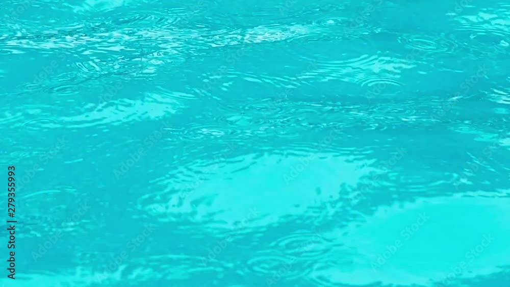 Heavy raining droplets hitting on the surface of swimming pool and ...