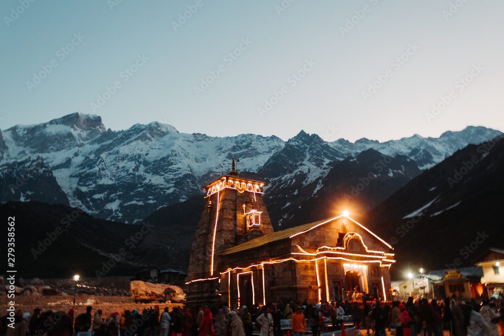View of the Kedarnath temple lights at night with mountains in the ...