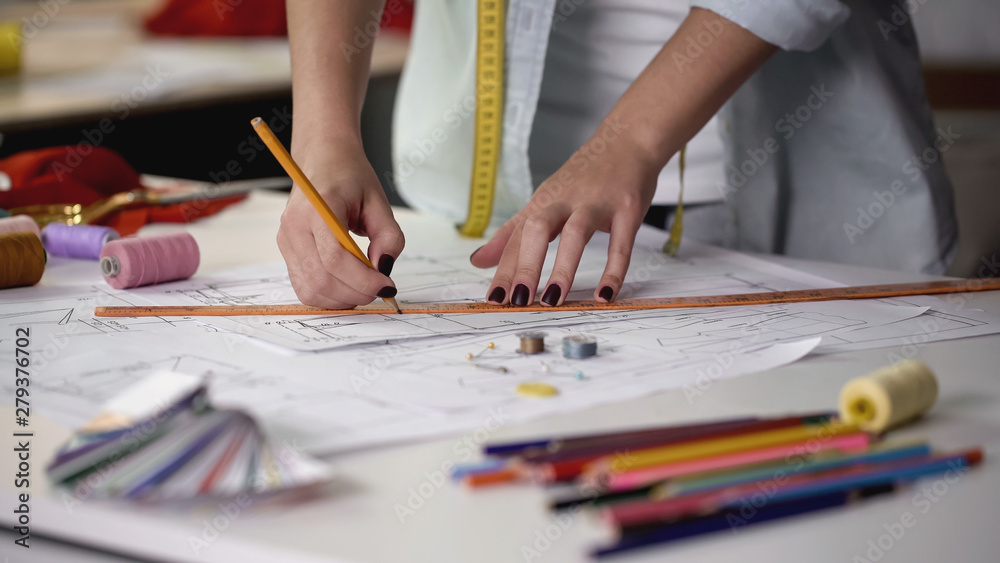 Designer drawing template for sewing new dress according to her ...