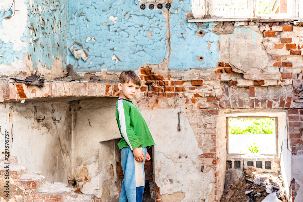 Orphaned children, poor child standing in a destroyed and abandoned ...