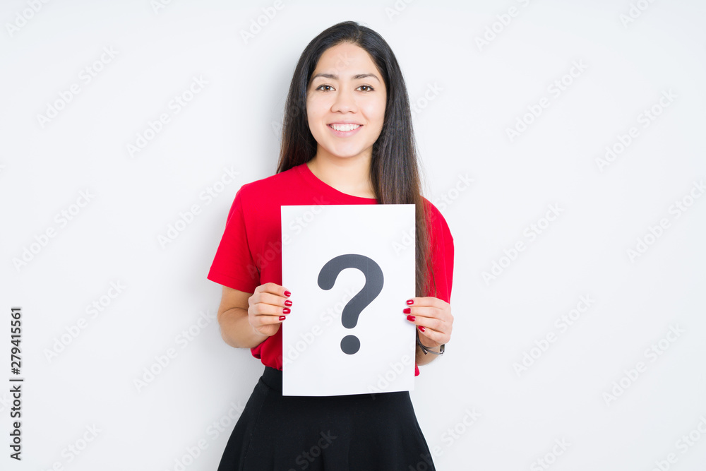 Young brunette woman holding paper with question mark over isolated ...