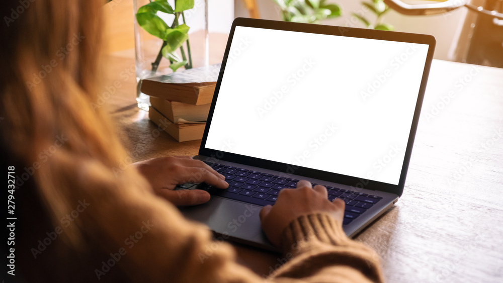 Mockup image of a woman using and typing on laptop with blank white ...