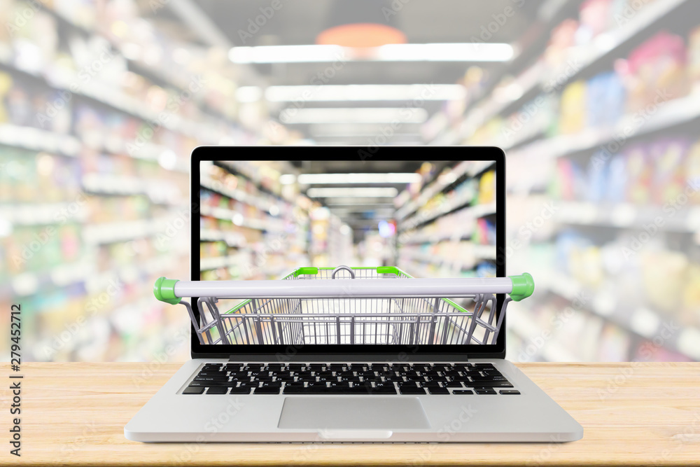 supermarket aisle blurred background with laptop computer and shopping ...