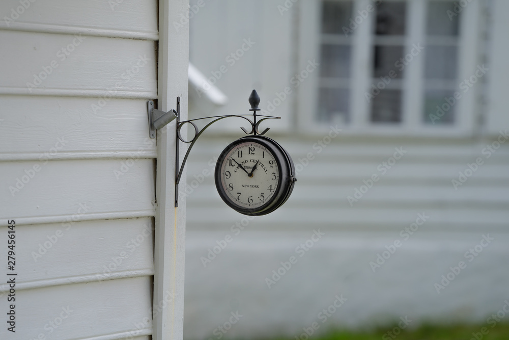 : House decoration. Clock face showing 12:52 attached to the wall next ...